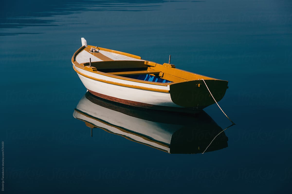 "Old Wooden Boat On The Calm Water Surface" by Stocksy Contributor ...