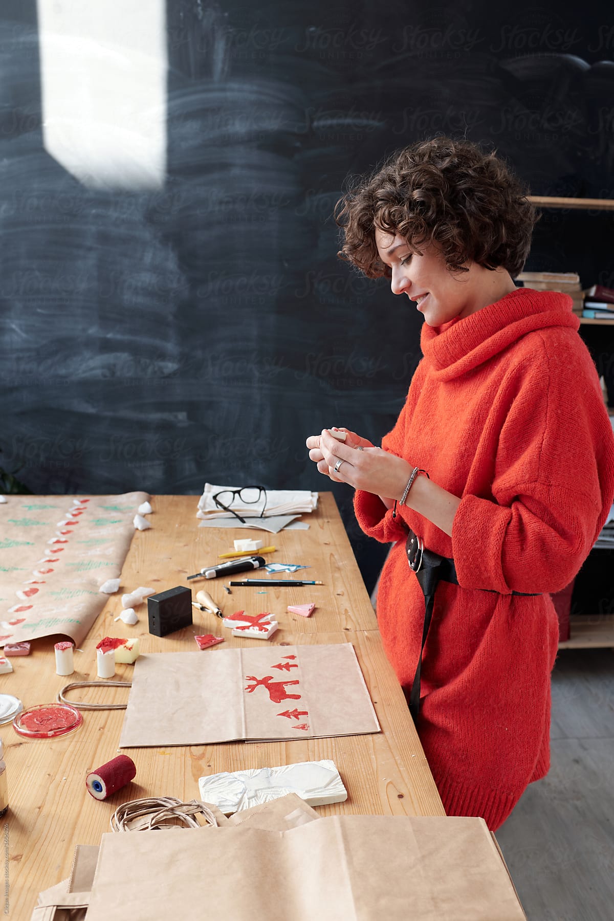 "Woman Decorating Paper Bags" by Stocksy Contributor "Clique Images ...