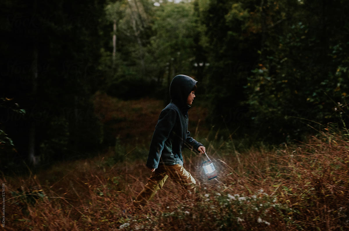 "Boy And A Lantern At Night" by Stocksy Contributor "Ali Deck" - Stocksy