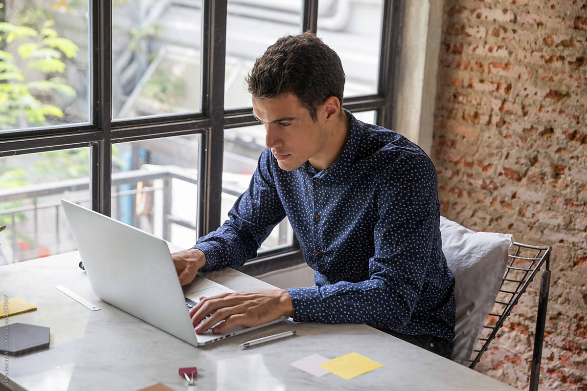 "Businessman Using Laptop In Office" by Stocksy Contributor "Jovo ...