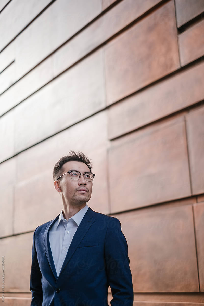 "Business Man Standing In Front Of A Brown Wall" by Stocksy Contributor ...