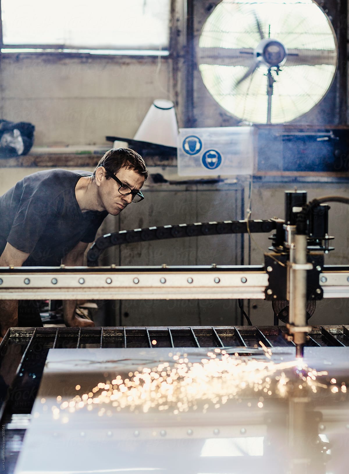 "Young Working Man Supervising Plasma Cutting Machinery" by Stocksy ...