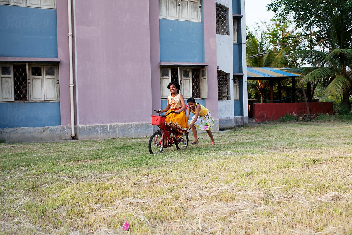 "Teenage Girl Pushing Cycle And Making Fun" by Stocksy Contributor ...