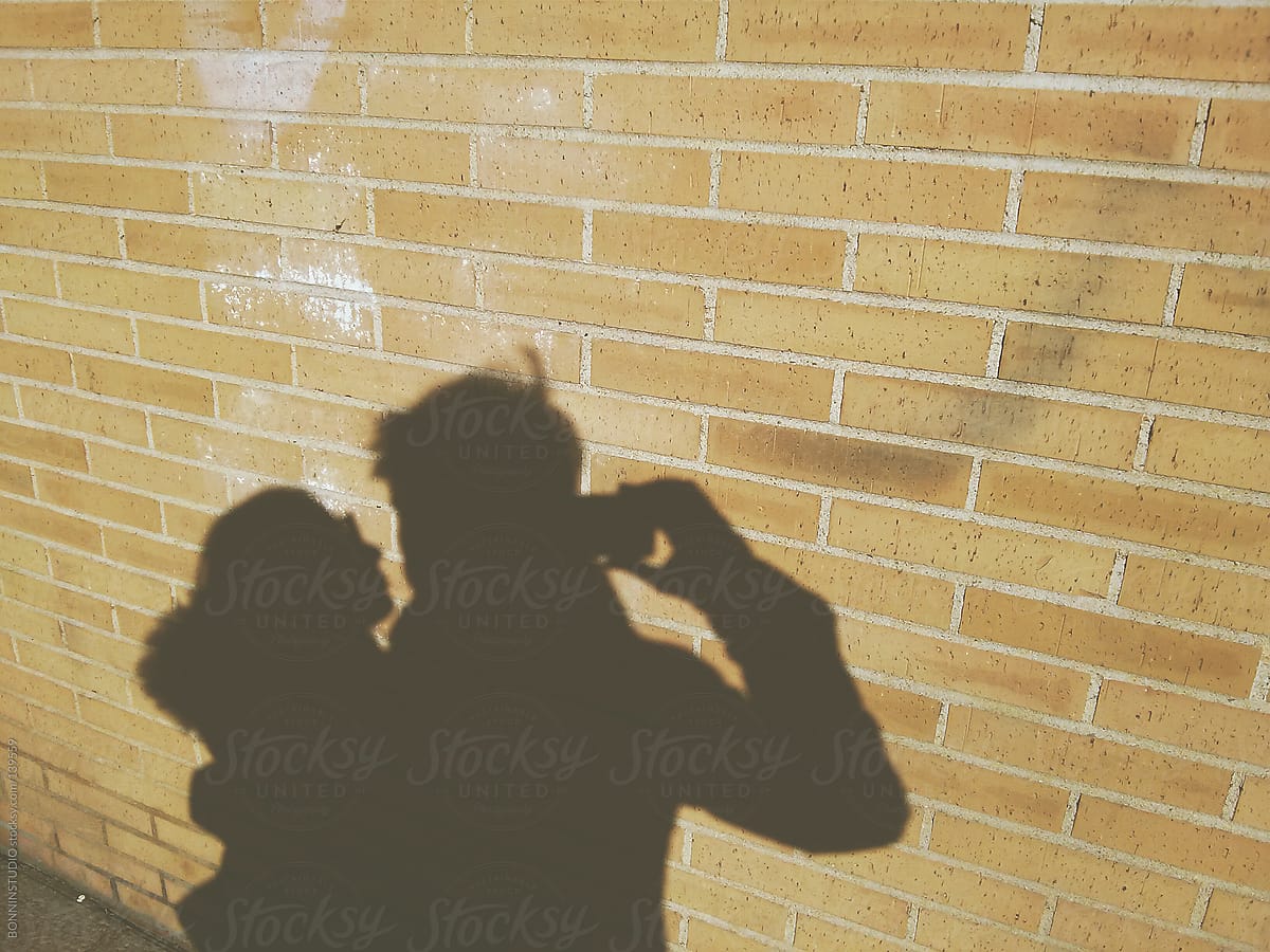 "The Shadow Of A Couple On A Brick Wall." by Stocksy Contributor ...
