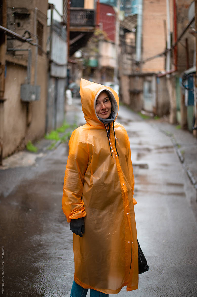 "Young Woman Wears An Orange Raincoat In The Streets Of Tbilisi ...