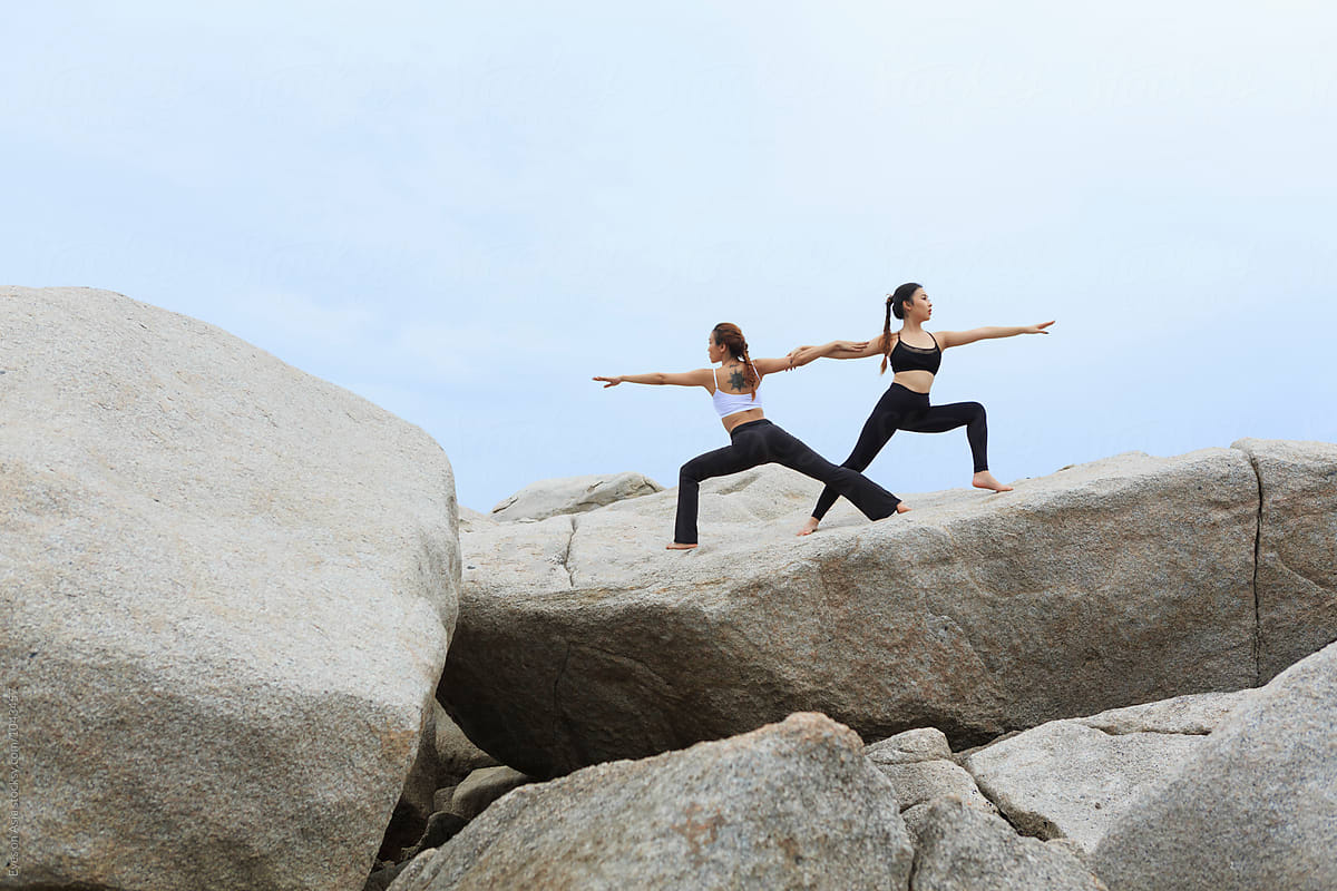 "Two Women In Interlinked Warrior Poses" by Stocksy Contributor "Eyes ...