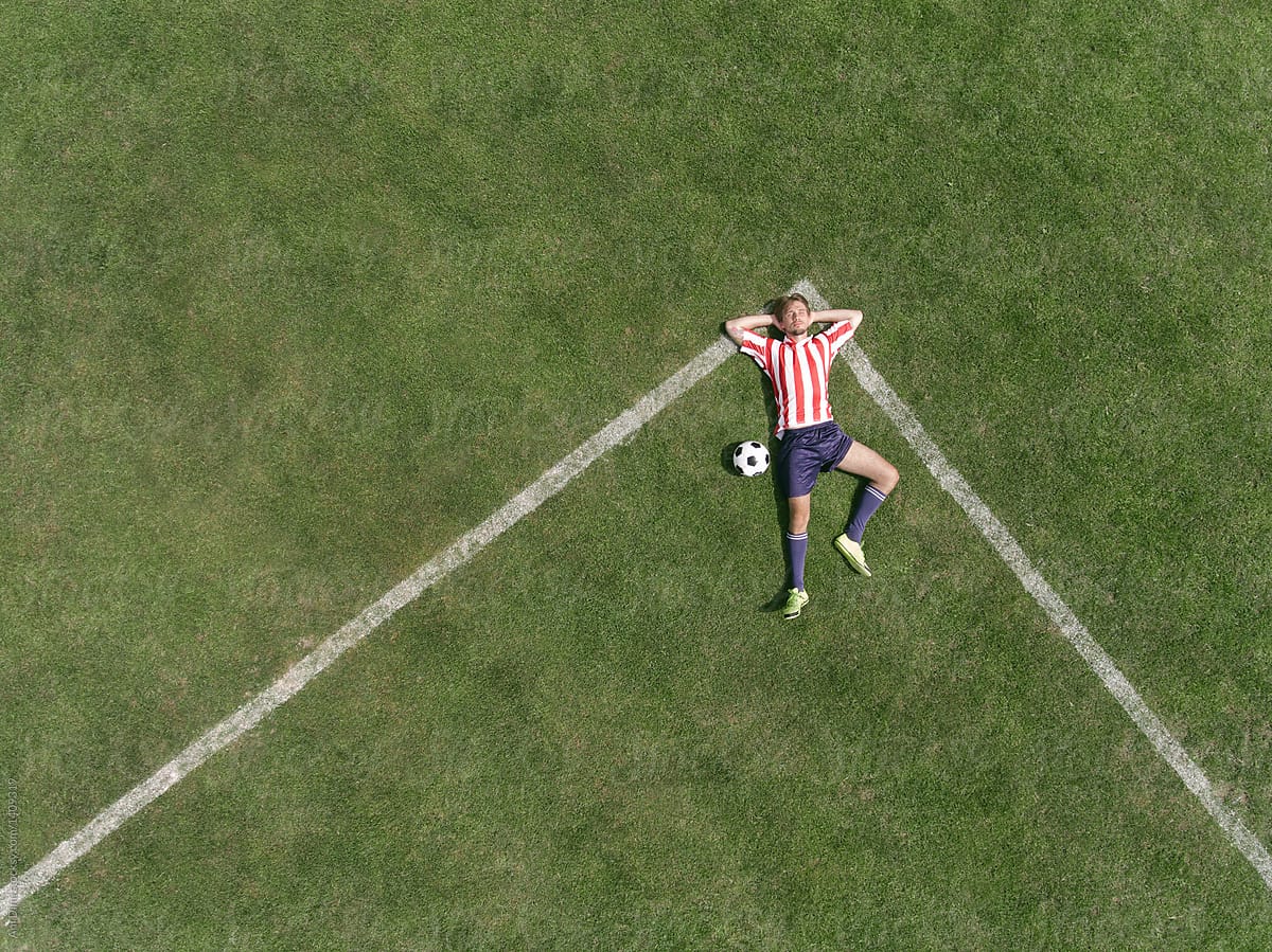 "Football Player Laying On The Grass" by Stocksy Contributor "Ani Dimi ...