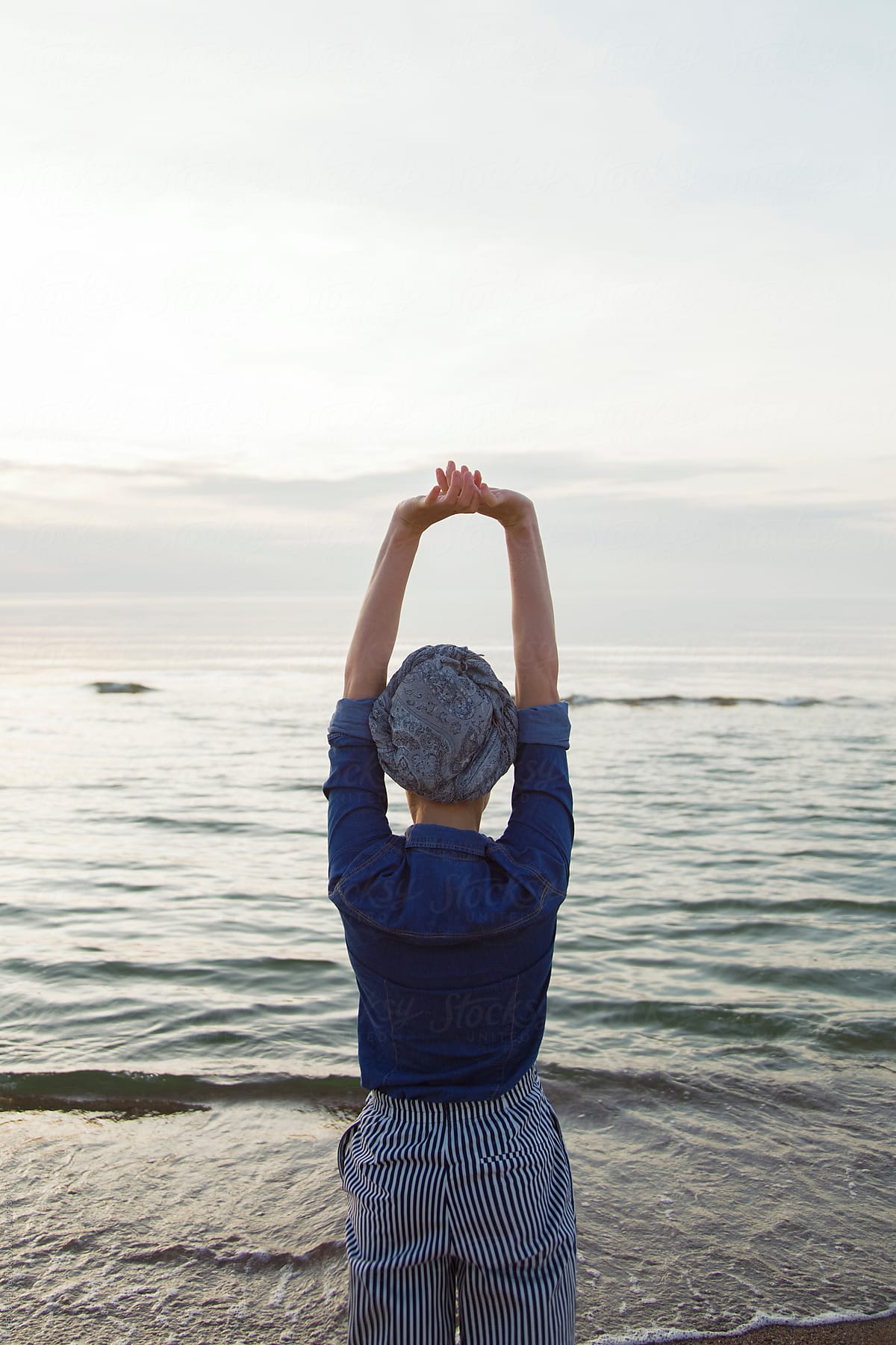 "Woman Stretching At Ocean" by Stocksy Contributor "Danil Nevsky" - Stocksy