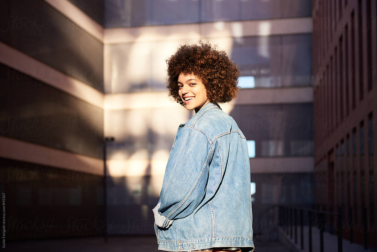 "Smiling Young Woman Looking Over Shoulder" by Stocksy Contributor ...