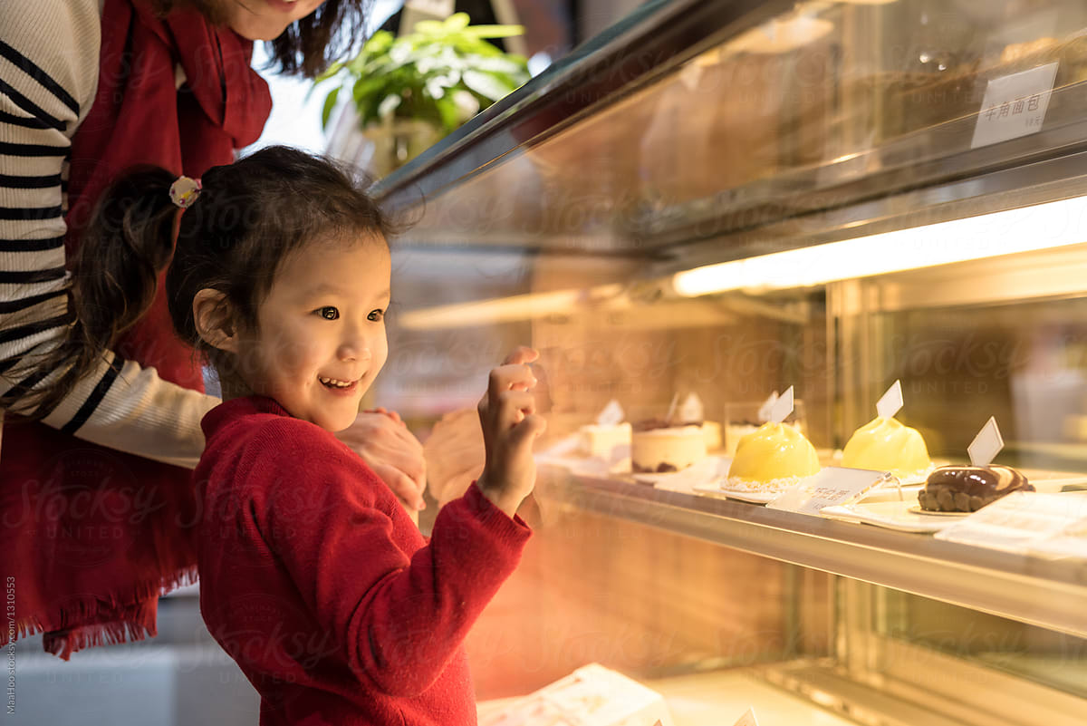 "Toddler Girl Looking At Cake Displays" by Stocksy Contributor "MaaHoo ...