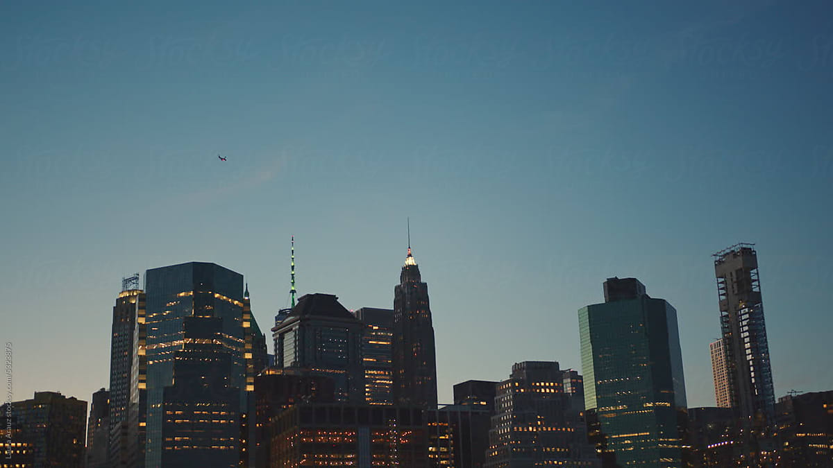 "Skyline Of New York City With Plane At Sunset" by Stocksy Contributor ...