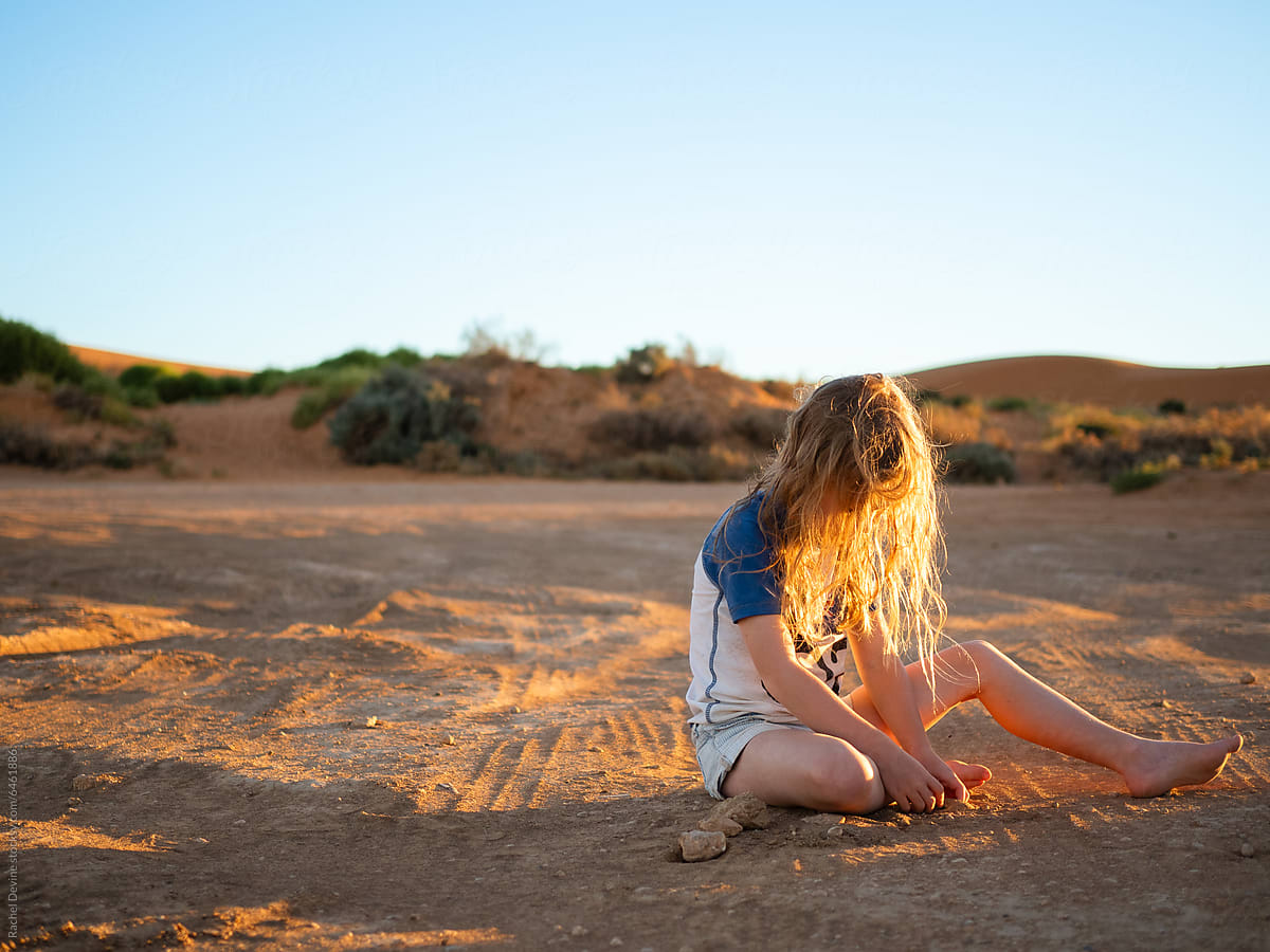 "Young Girl Sits And Plays In The Sands Of The Australian Outback" by ...