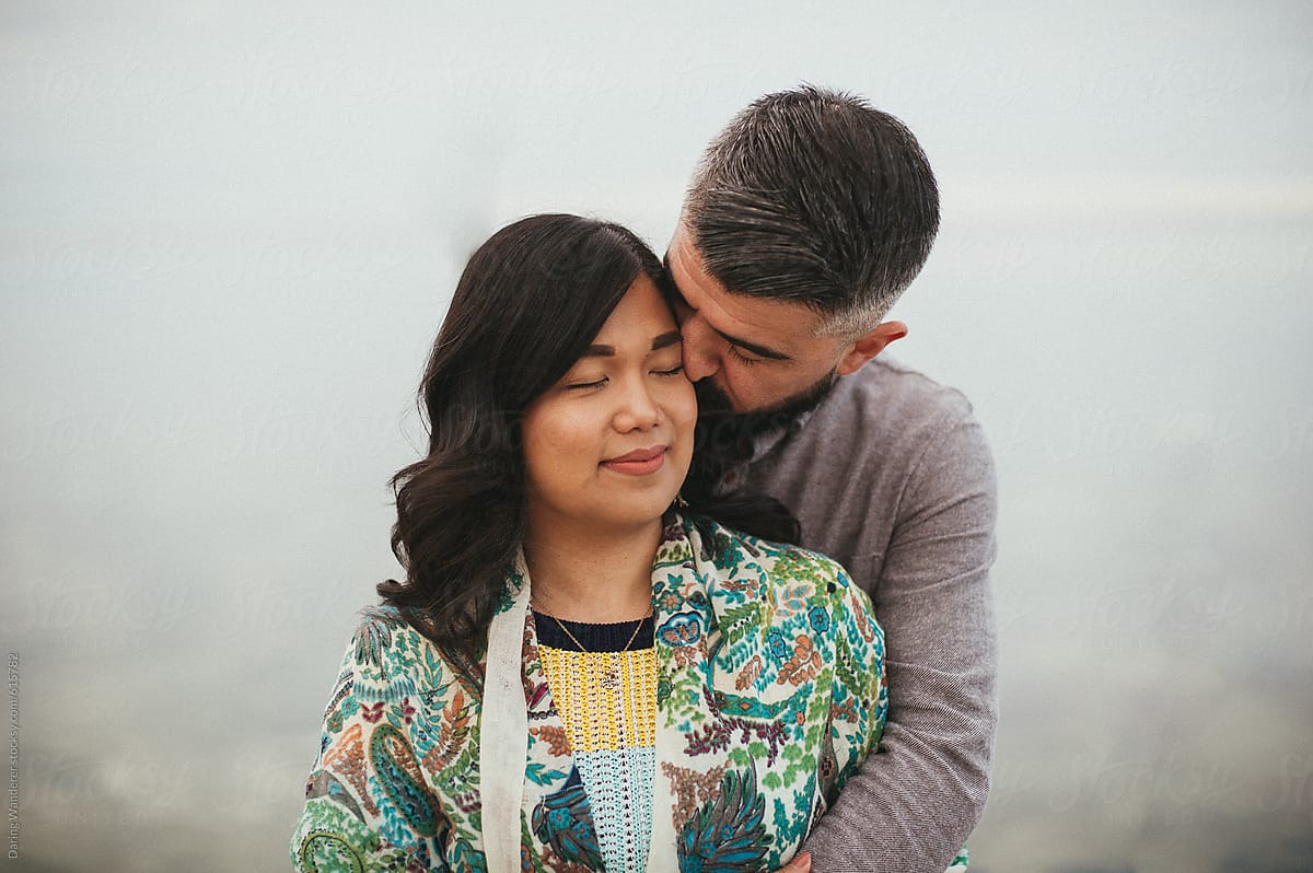 "Guy With Moustache Kissing Asian Girl" by Stocksy Contributor "Jess ...