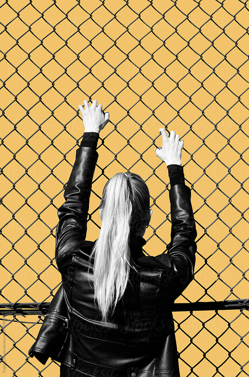 "Woman Looking Through The Fence" by Stocksy Contributor "Evgeniy ...