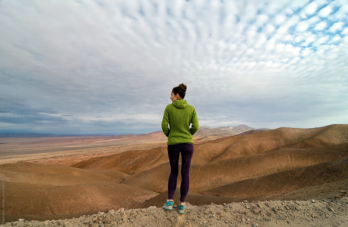 "Young Woman Overlooking Desert" by Stocksy Contributor "Alice Nerr ...