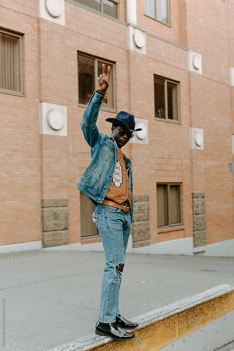 "Young Black Man Giving Peace Sign" by Stocksy Contributor "Luke Liable ...