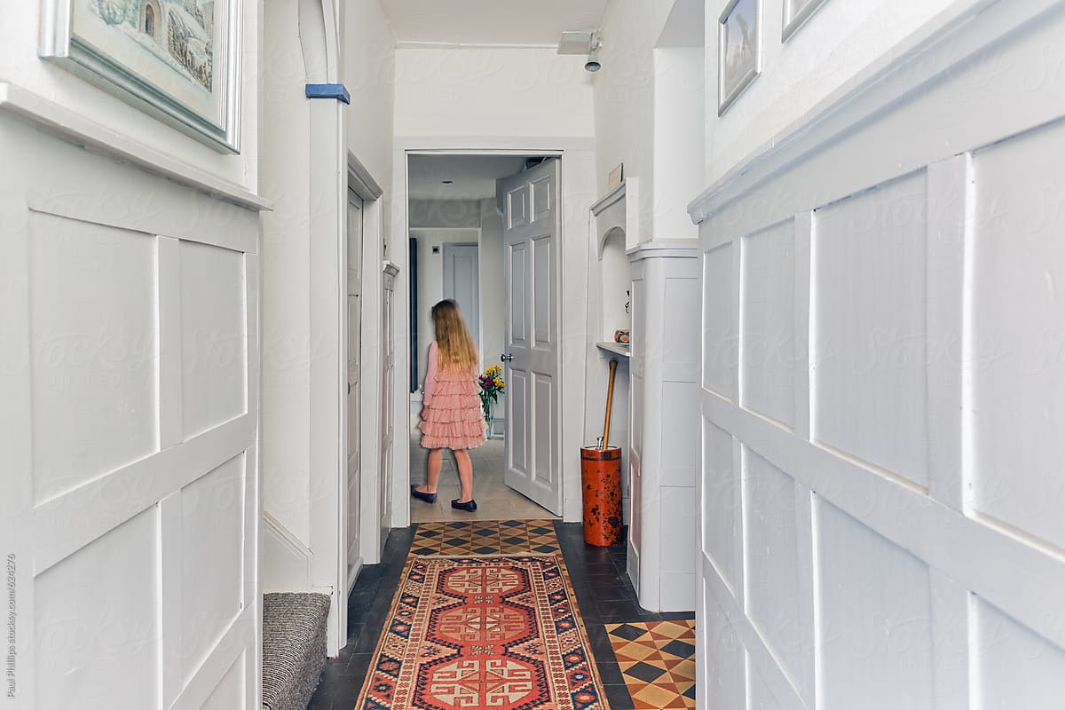 "Young Girl In A Pink Dress At The End Of A Hallway Going Through An ...