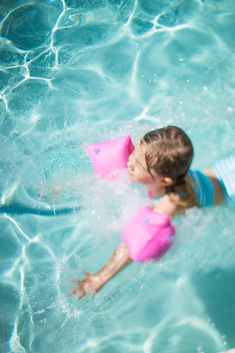 "Girl Jumps Into Pool Summer Fun" by Stocksy Contributor "SKC" - Stocksy