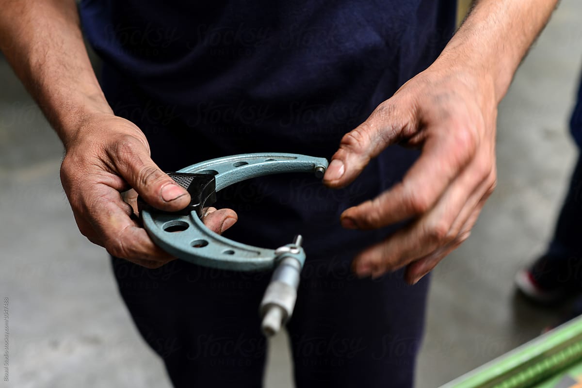 "A Mechanic Holding A Tool On A Workshop" by Stocksy Contributor ...