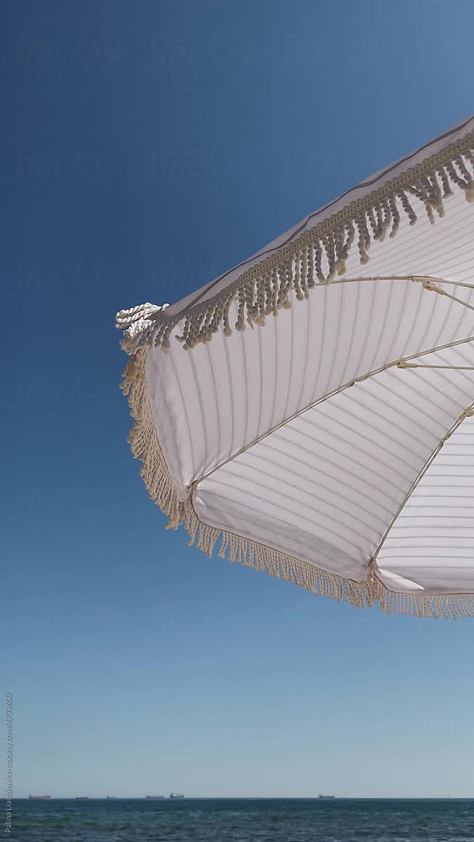 "Stylish Parasol On The Beach." by Stocksy Contributor "Palina ...