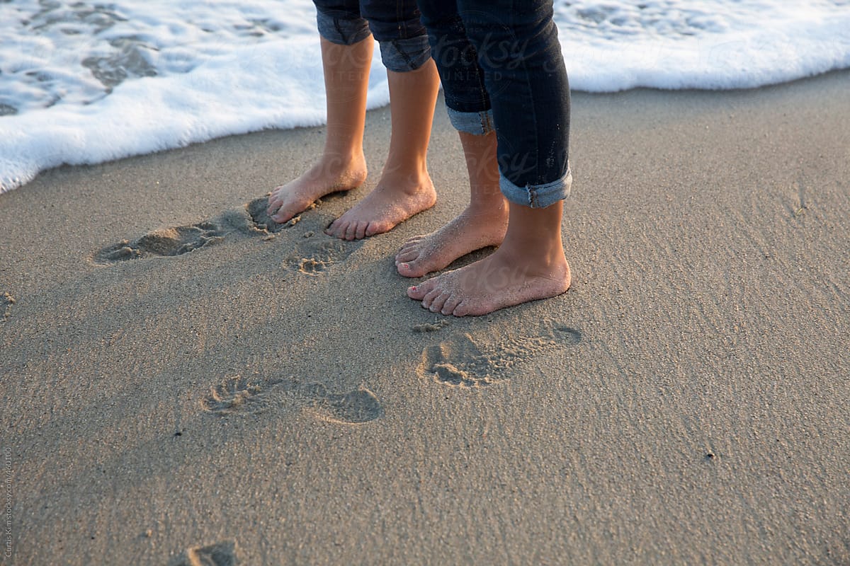 "Ocean Wave Approaches Feet On The Sand" by Stocksy Contributor "Curtis ...