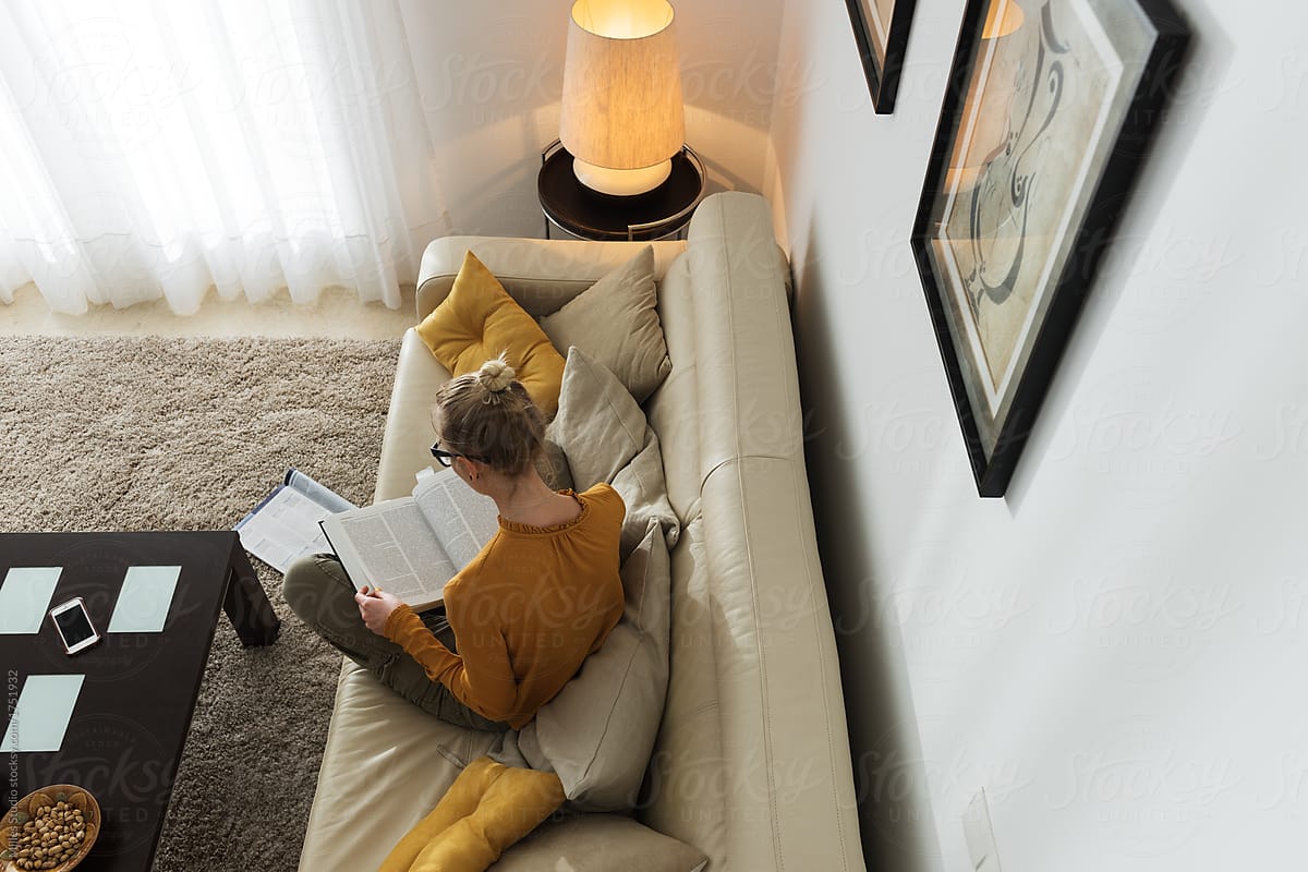 "Woman Reading Book At Home" by Stocksy Contributor "Milles Team" - Stocksy