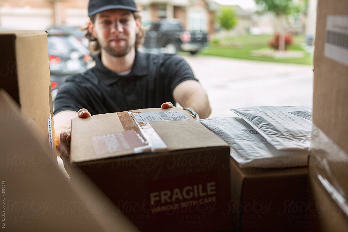 "Shipment: Man Getting Boxes Out Of Delivery Van" by Stocksy ...