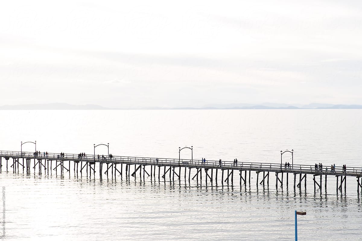 "Minimal Pier At Beach" by Stocksy Contributor "Sophia Hsin" - Stocksy