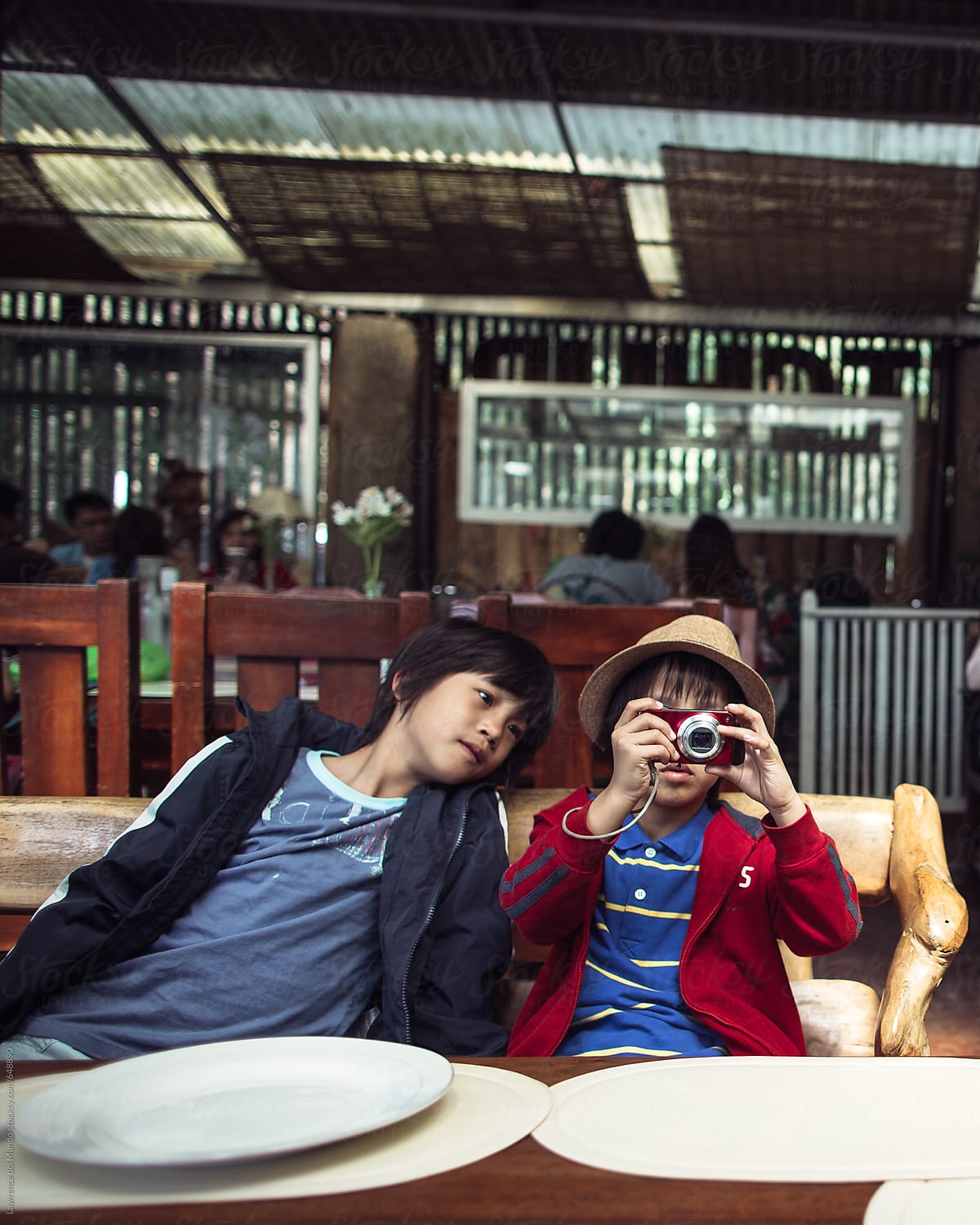 "Two Brothers Taking Photos While Waiting For Their Food Orders" by ...