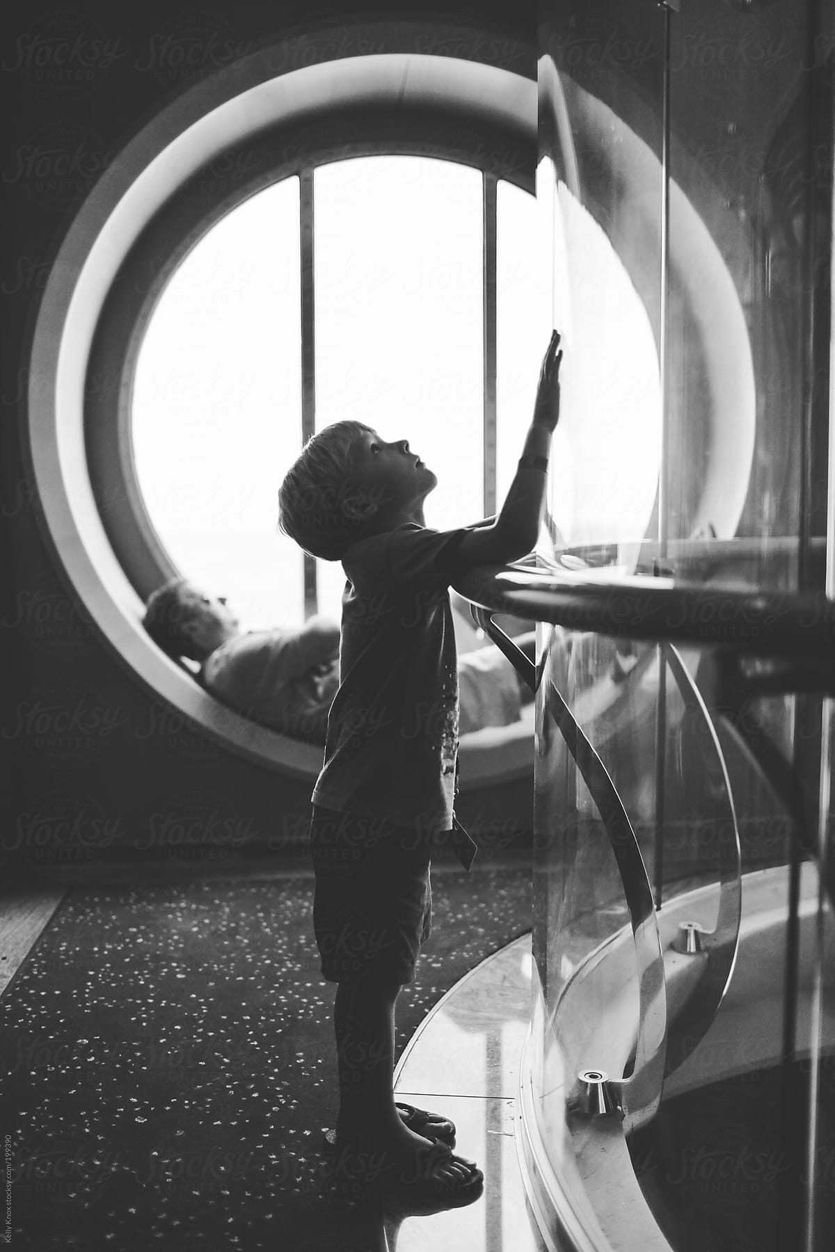 "Curious Child Watches A Glass Elevator" by Stocksy Contributor "Kelly ...