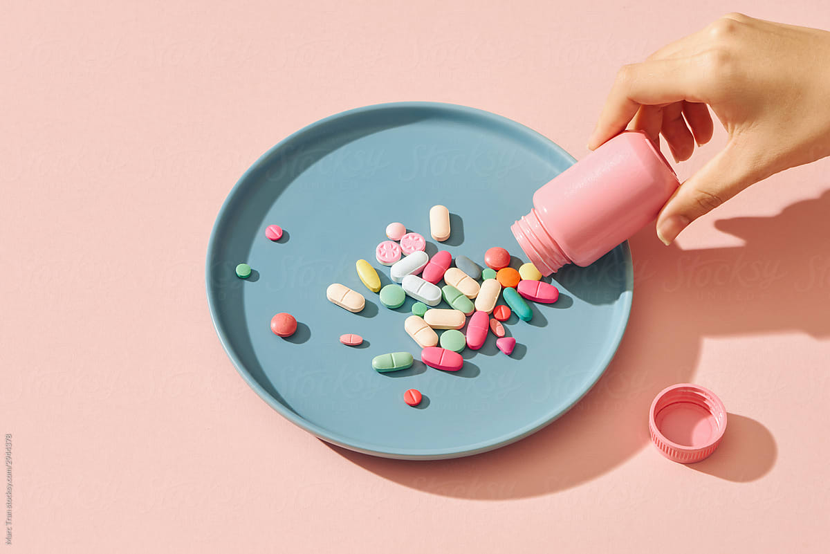 "Woman Hand Pouring Pills From A Pillbox Into The Plate" by Stocksy ...