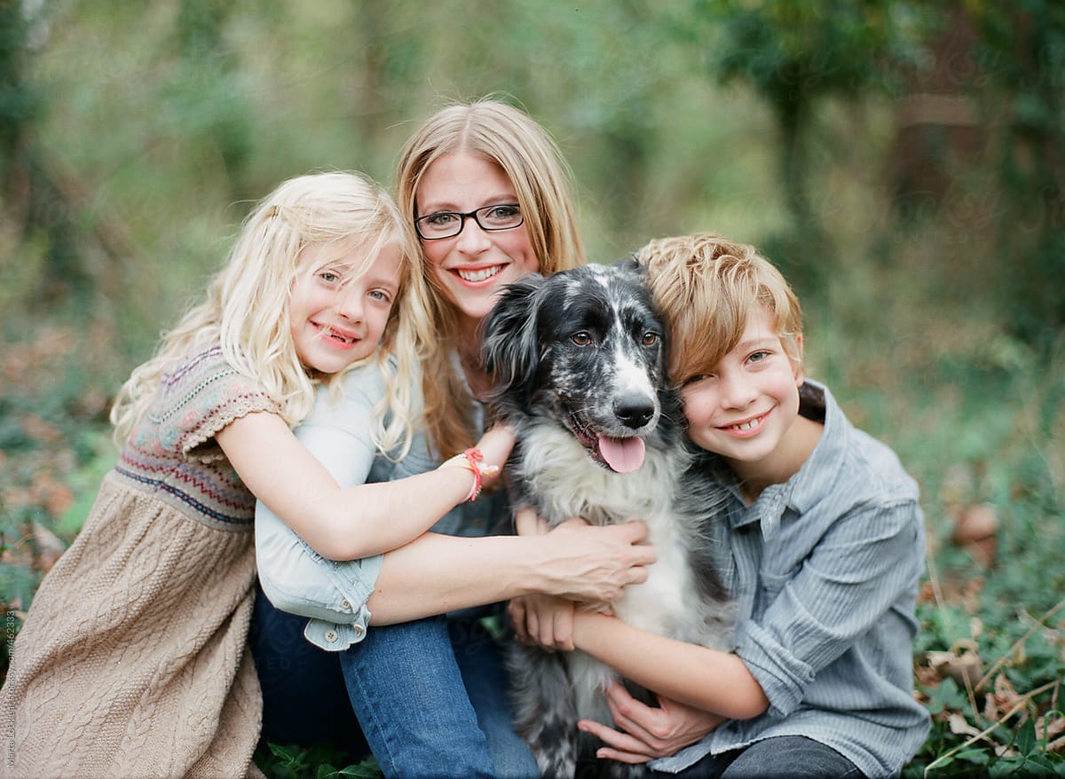 "Family Of Three Sitting In The Ivy Woods With Their Pet Dog" by ...