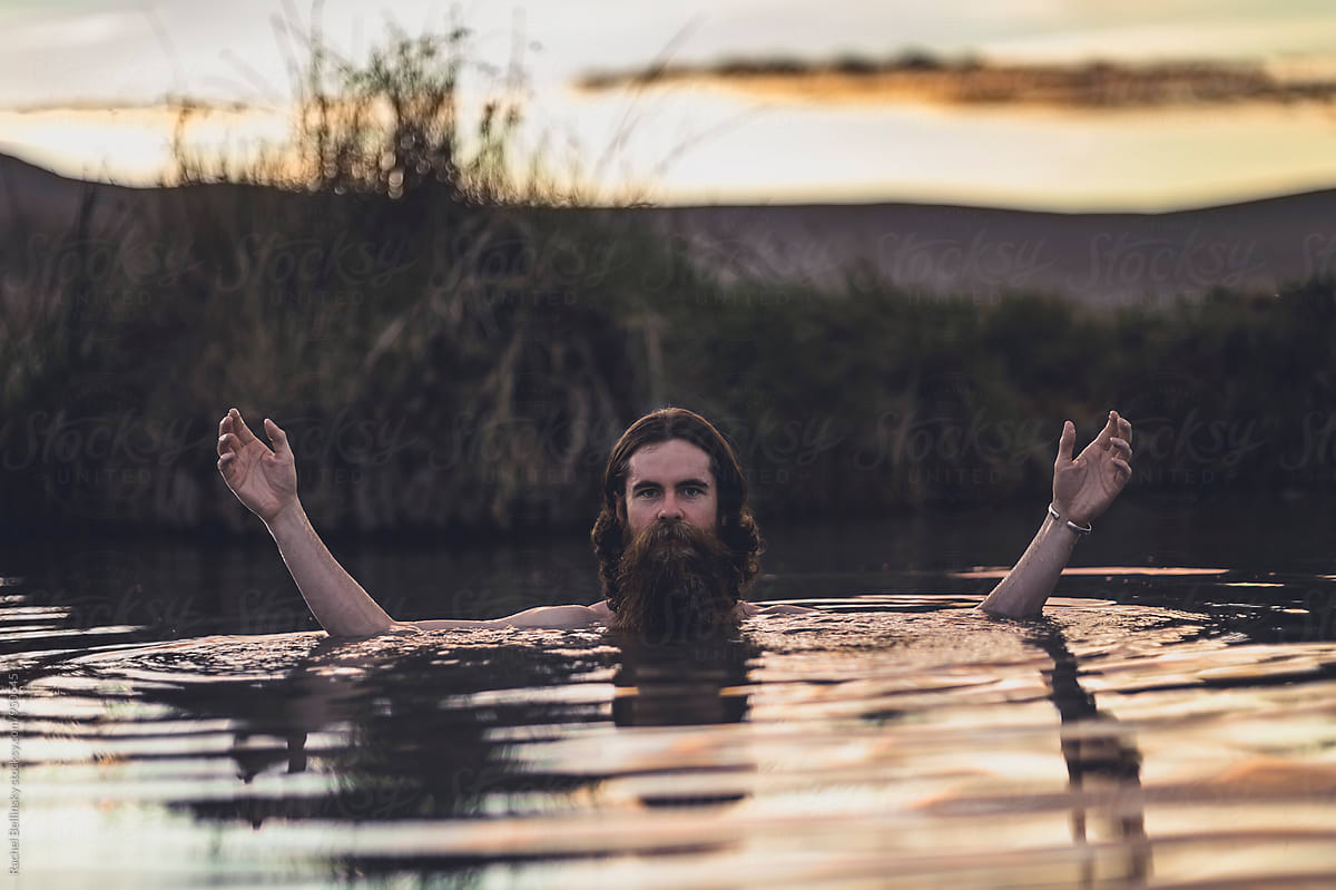 "A Bearded Man Resembling Jesus Submerged In Water At Sunset" by ...
