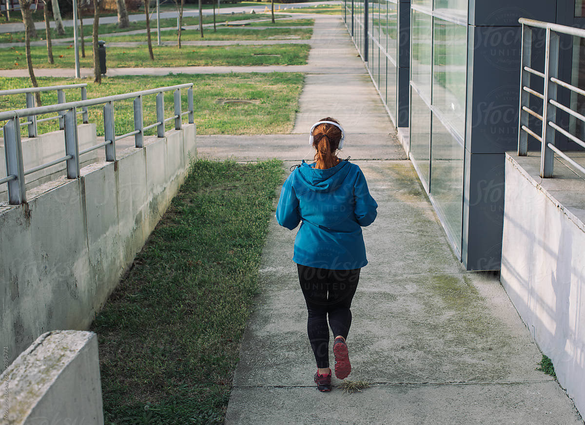 "Woman Jogging In The City" by Stocksy Contributor "Mosuno" - Stocksy