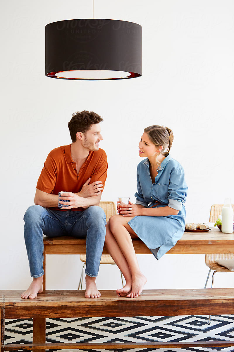 "Young Couple Talking While Sitting On Breakfast Table" by Stocksy ...