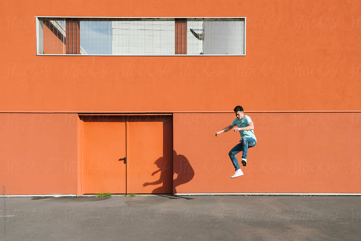 "Asian Man Jumping In Urban Area" by Stocksy Contributor "Koganami ...