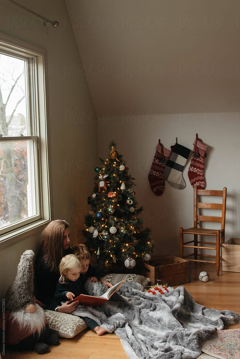 "A Family Sitting By The Christmas Tree And Relaxing" by Stocksy ...