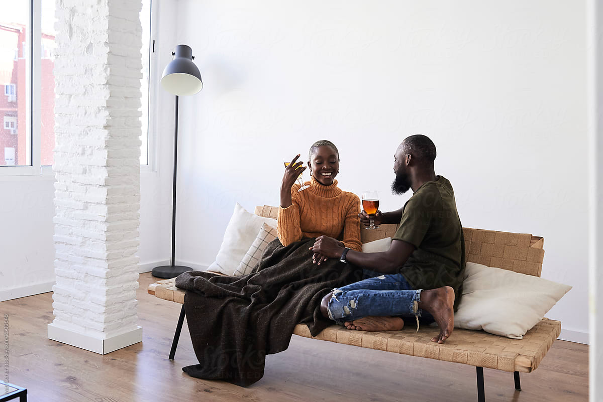 "Ethnic Couple Drinking Beer Home." by Stocksy Contributor "Ivan Gener ...