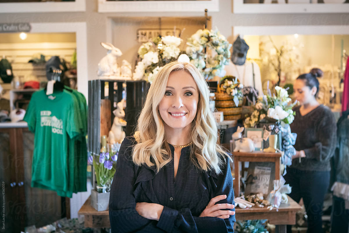 "Boutique: Store Shop Owner Smiles With Customer In Background" by ...