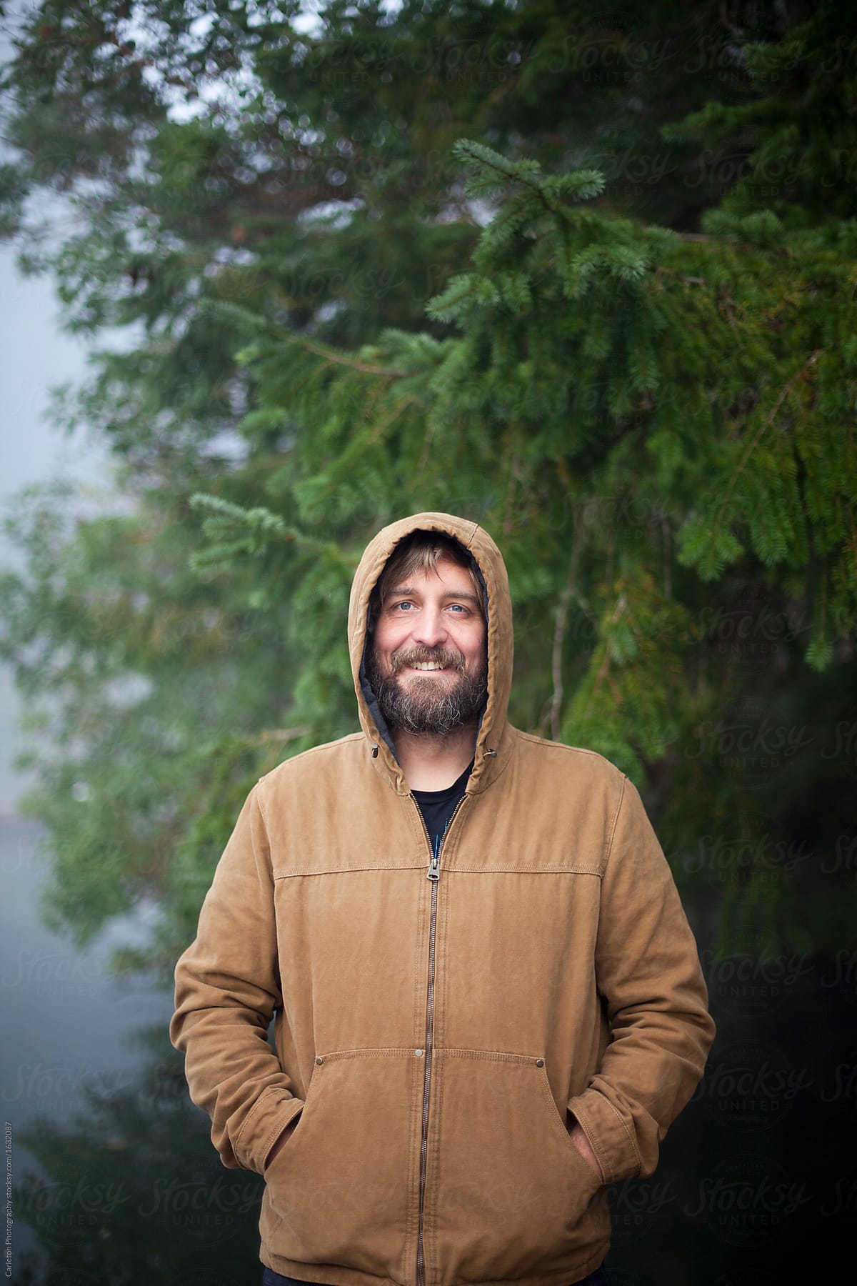 "Man In Hooded Jacket Stands On A Dock In Fletcher Bay On A Foggy ...