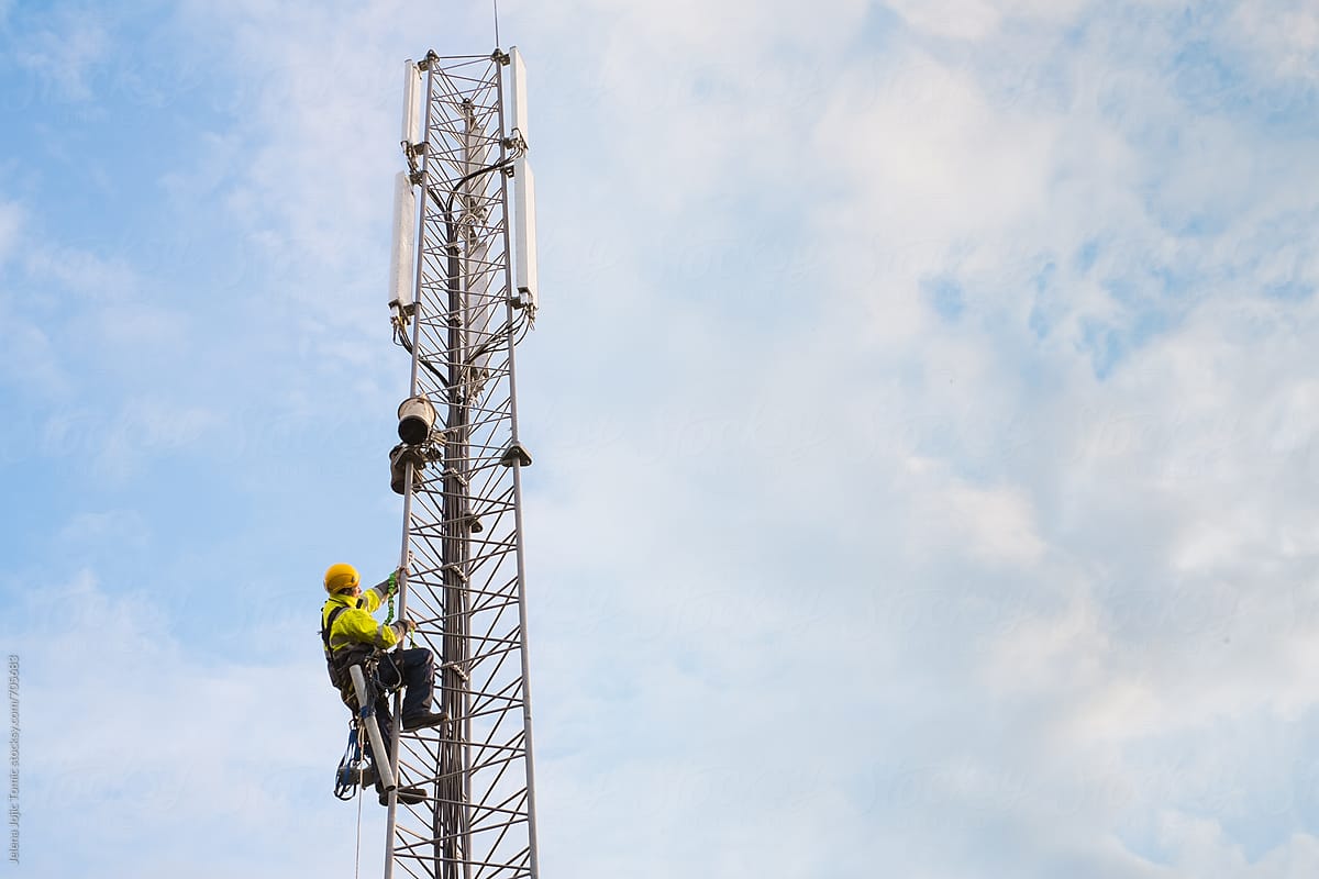"Working At Heights, Technician Climbs Up On A Communications Tower" by ...