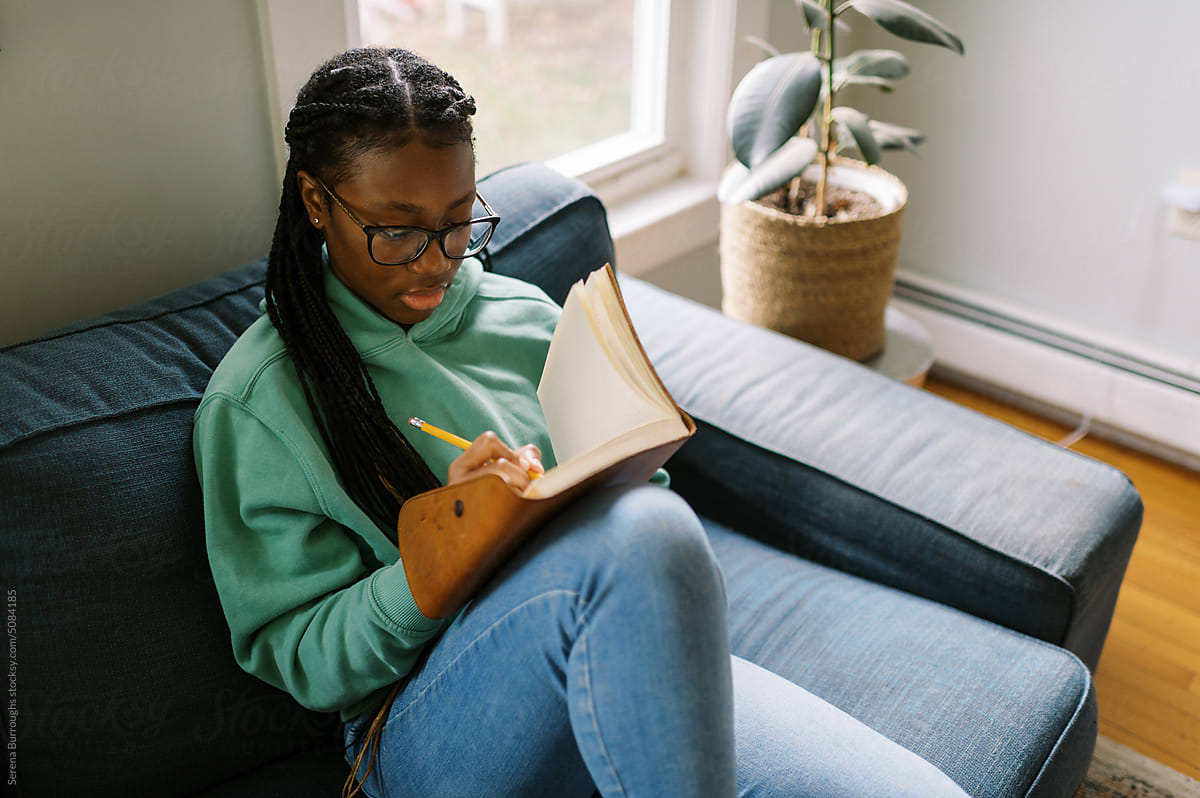 "Black Teenage Girl Sitting Down Writing In A Journal" by Stocksy ...