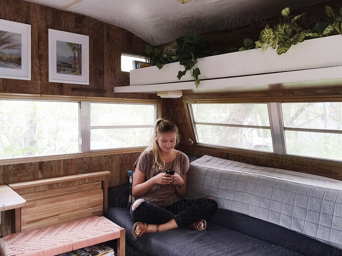 "Attractive Young Woman Hanging Out In Renovated Trailer, Using Her ...