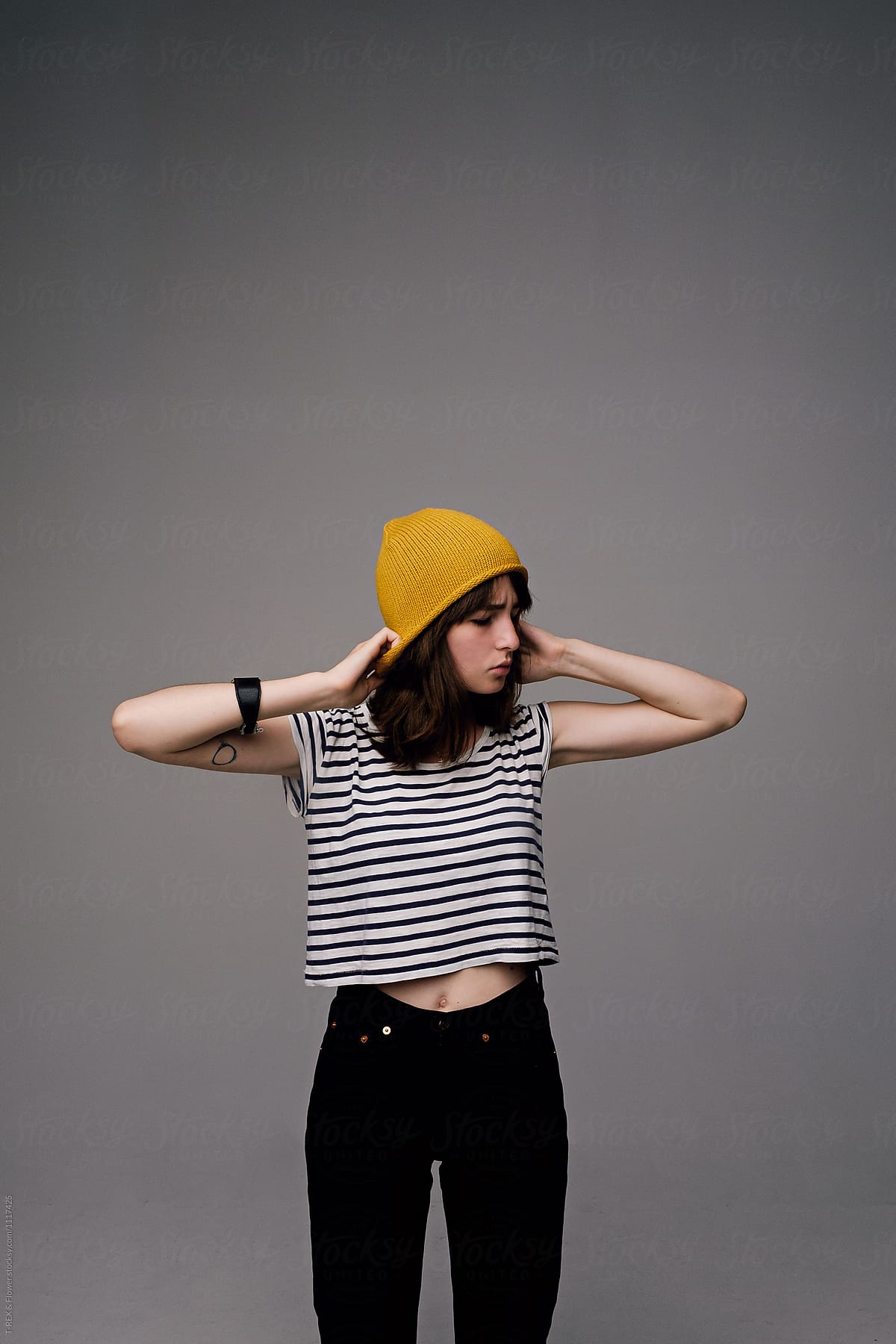"Young Girl In Yellow Knitted Hat Looking Down" by Stocksy Contributor ...