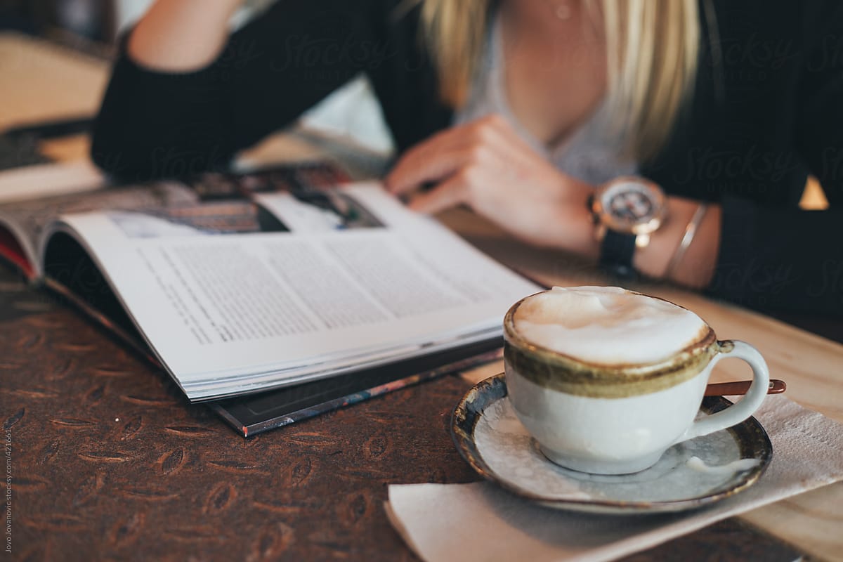 "Blonde Woman Reading Book While Drinking Coffee" by Stocksy ...