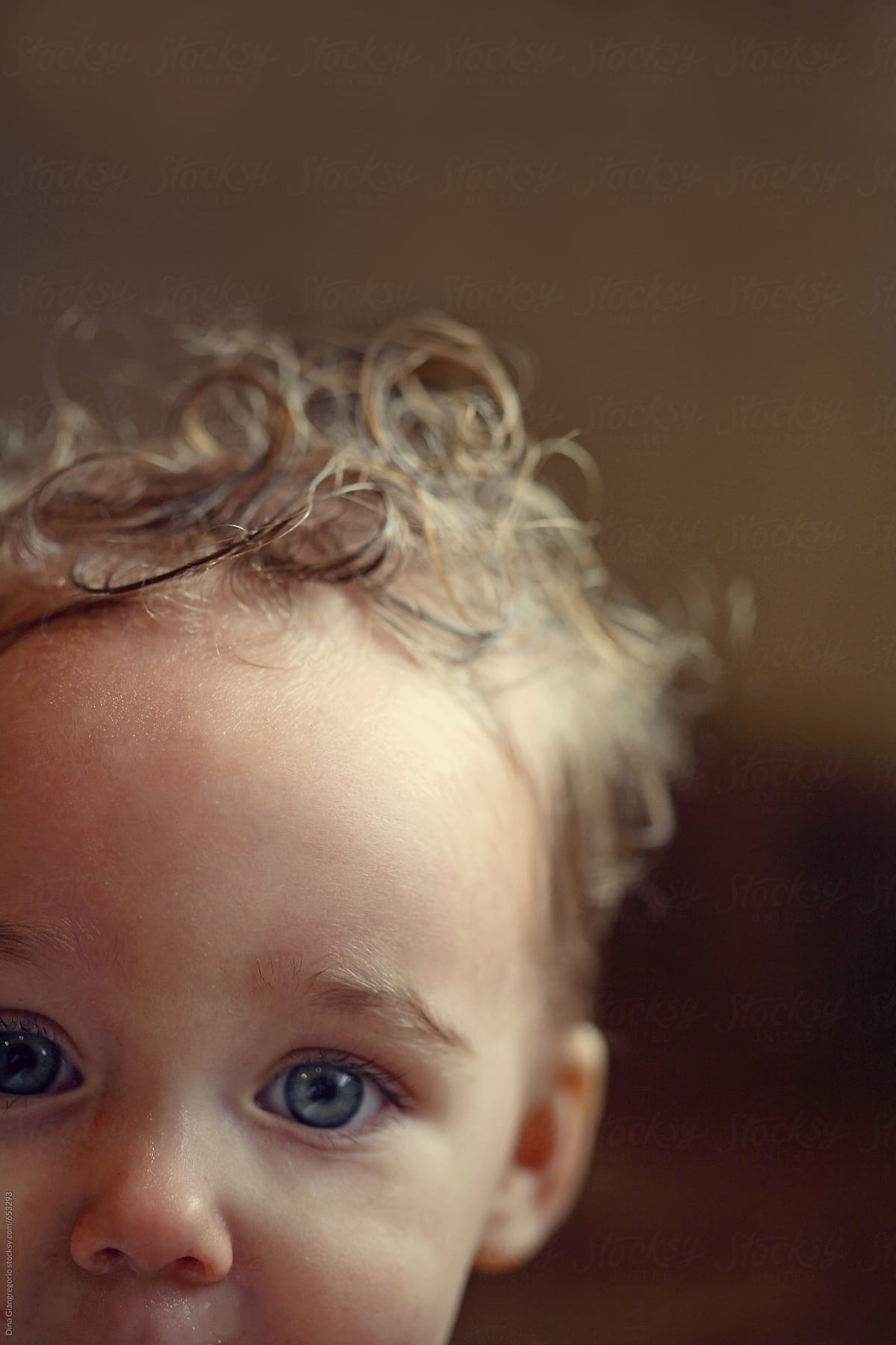 "Partial Crop Of Curly Haired Baby'" by Stocksy Contributor "Dina Marie ...