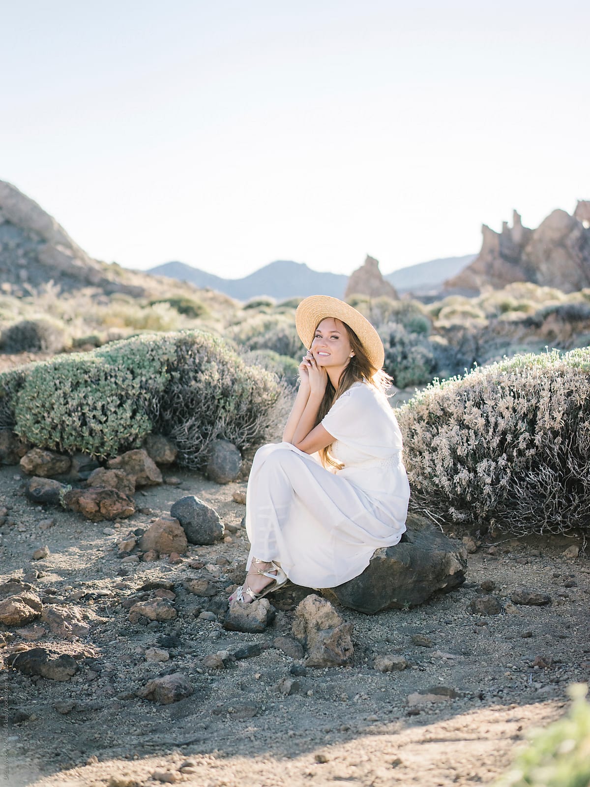 "Smiling Woman Sitting On Stone" by Stocksy Contributor "Dreamwood ...