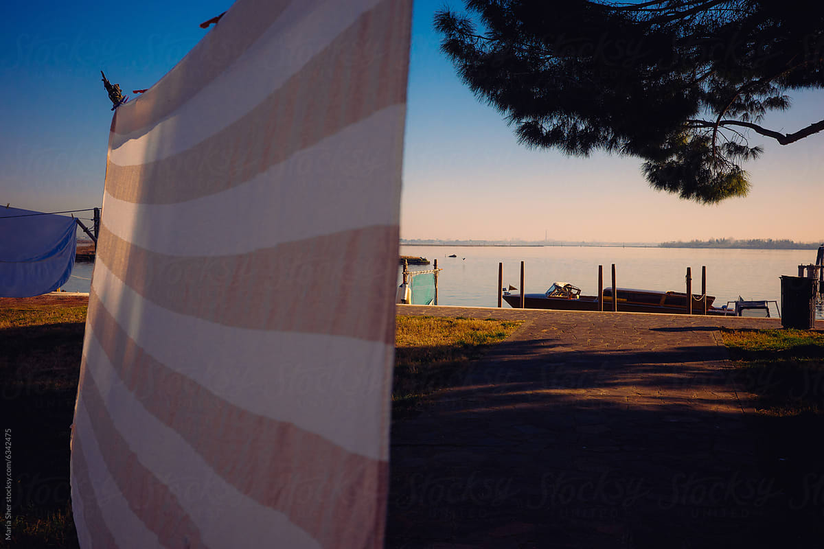 "Cloth Drying On A Line By A Lakeside With A Boat And Peaceful Water ...